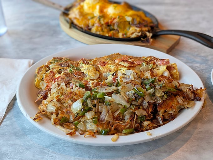 Not all heroes wear capes – some arrive on white plates. This mountain of hash browns could make a grown adult weep with joy.