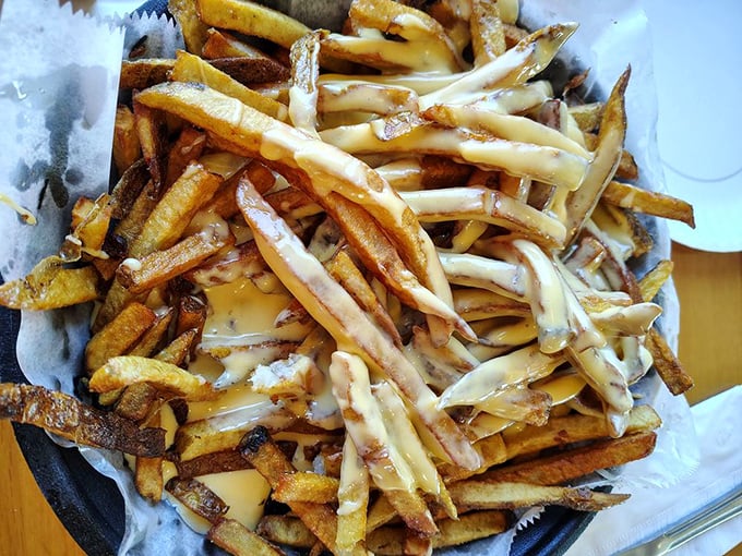 Mount Vesuvius has nothing on this golden volcano of cheese-covered fries – prepare for delicious destruction.