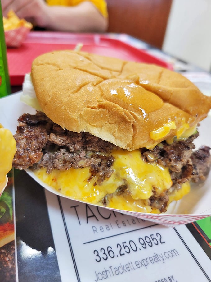Cheese cascading down the sides of a hand-formed patty like a delicious yellow waterfall. This cheeseburger doesn't need a fancy introduction—it speaks for itself.