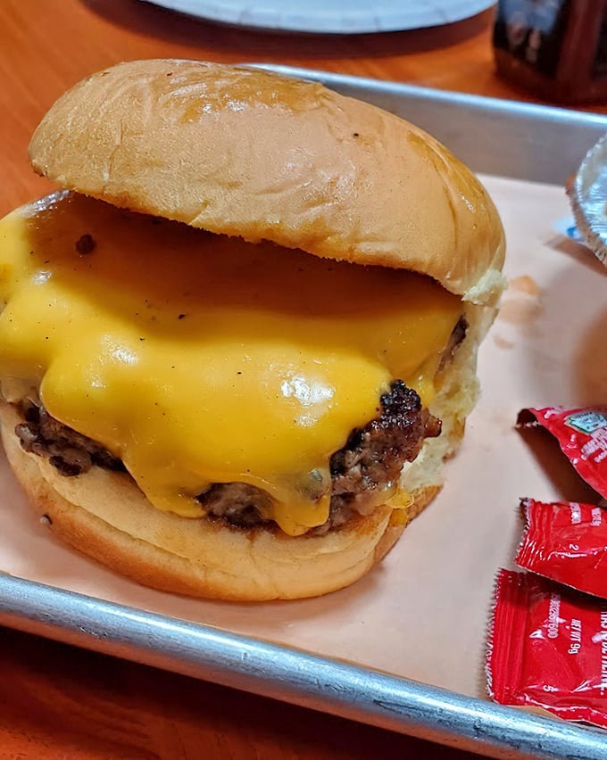 This isn't just a cheeseburger – it's a commitment to happiness. The melted cheese cascades down the sides like a yellow waterfall of joy.