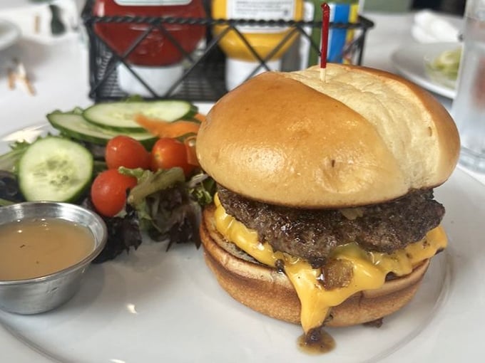 This isn't just a burger—it's a masterpiece of melted cheese cascading down a juicy patty like Niagara Falls, if Niagara Falls made your mouth water this much.