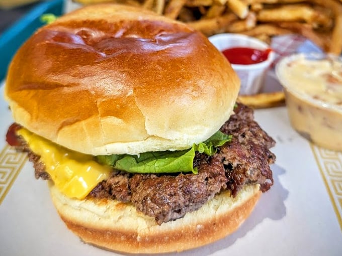 This isn't just a burger—it's a hand-formed monument to beef on a pillowy throne, waiting for its coronation in your mouth.