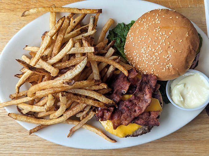 This isn't just a burger and fries—it's edible architecture with perfect structural integrity and a foundation of hand-cut potatoes.