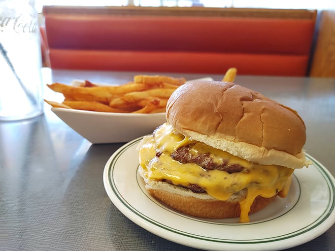 A proper diner cheeseburger doesn't need truffle aioli or artisanal buns – just melty American cheese cascading down a juicy patty like a yellow waterfall.