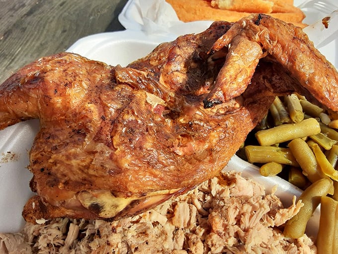 B's chicken, smoke-kissed and glistening, shares the plate with its pork cousin. This bird didn't fly south for the winter—it found a better destination.