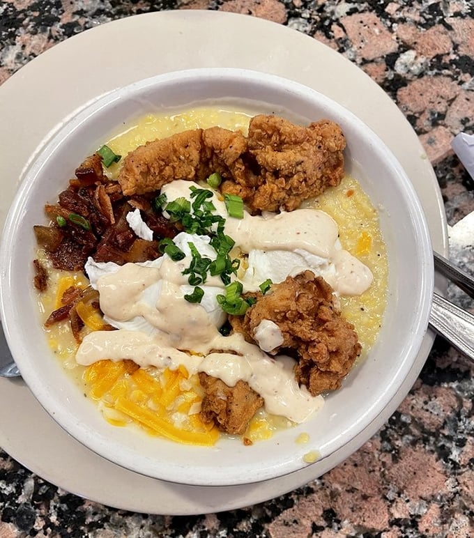 Southern comfort in a bowl. Crispy fried chicken nestles into creamy grits topped with gravy—proof that some traditions deserve to be preserved and savored slowly.