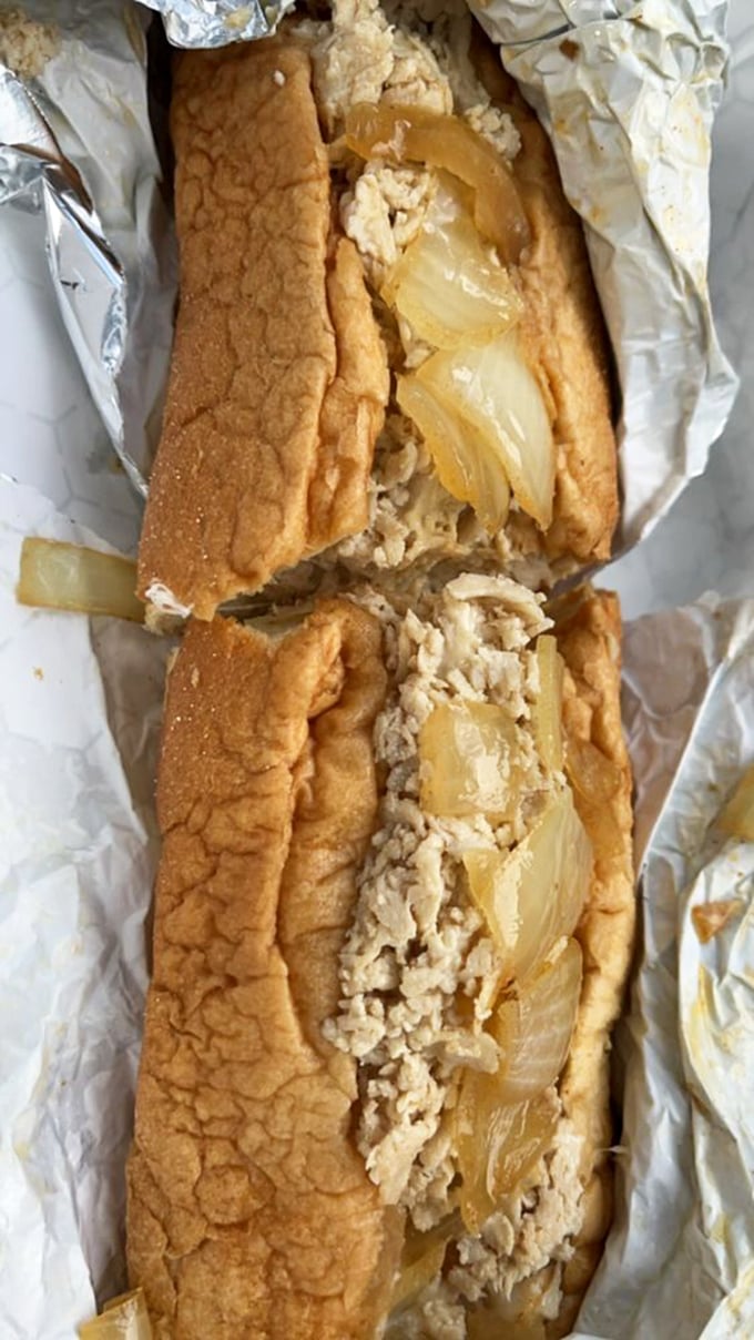 The cross-section reveals the magic: that signature fine chop creates a texture that melts in your mouth. This isn't a sandwich; it's an experience.