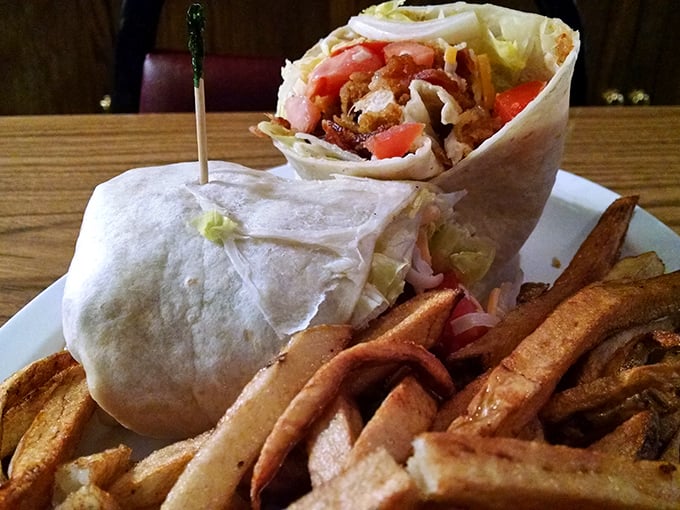 A wrap that requires both hands and a strategy. Those fries aren't a side dish—they're co-stars in this lunch production.