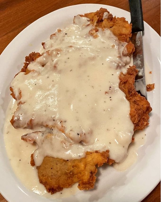 Chicken fried steak swimming in creamy gravy—the Texas equivalent of a warm hug from your favorite aunt who never understood portion control.