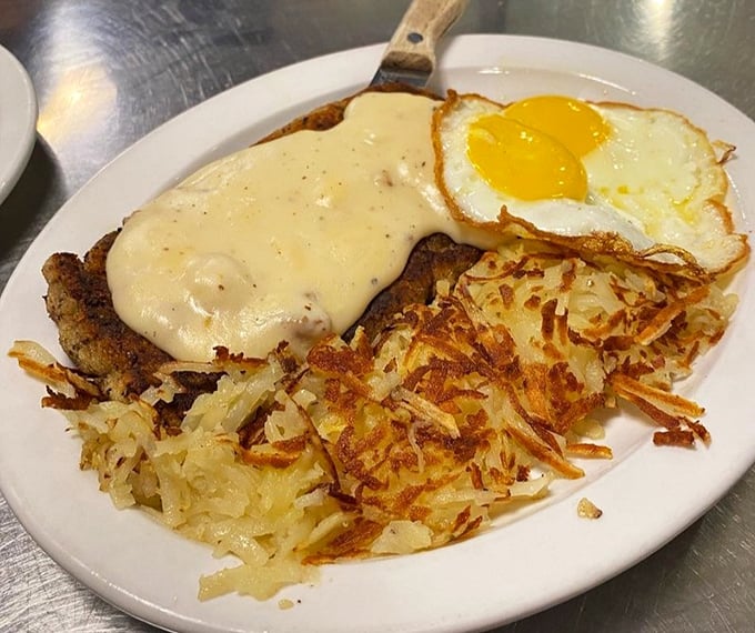 Chicken fried steak wearing a blanket of gravy like it's ready for a nap – and so will you be.