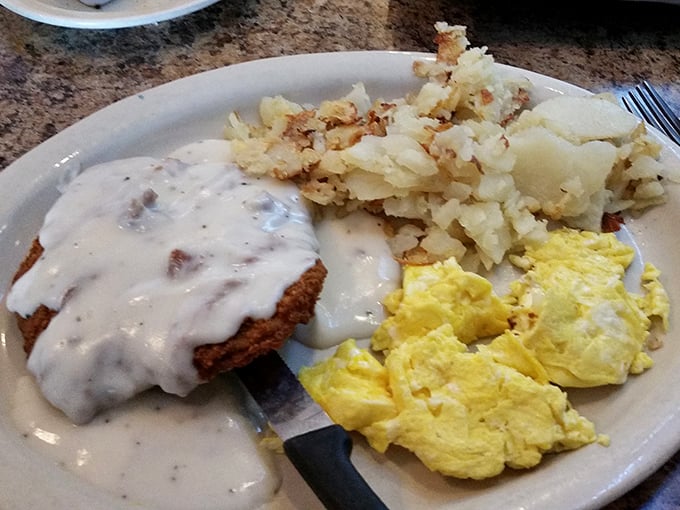 Country-fried steak smothered in gravy alongside golden home fries and fluffy eggs—the breakfast equivalent of a warm hug.