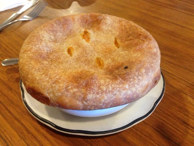 Not just any pot pie—this golden-crusted beauty is what comfort food dreams are made of, a warm hug served in ceramic.