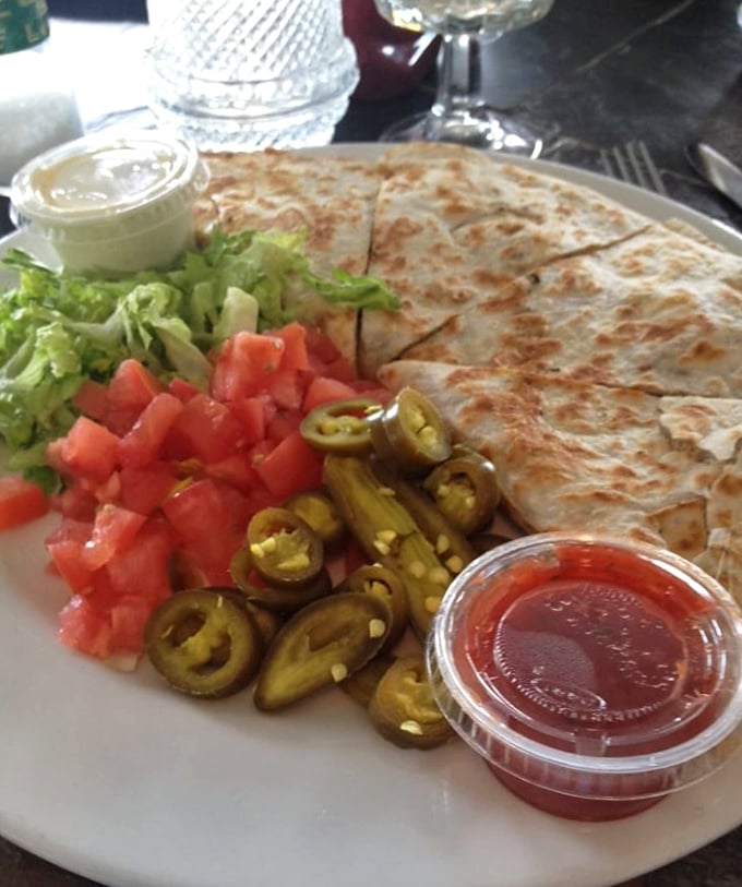 Not just any quesadilla—this one's a fiesta of flavors with jalapeños standing guard like spicy little sentinels of satisfaction.