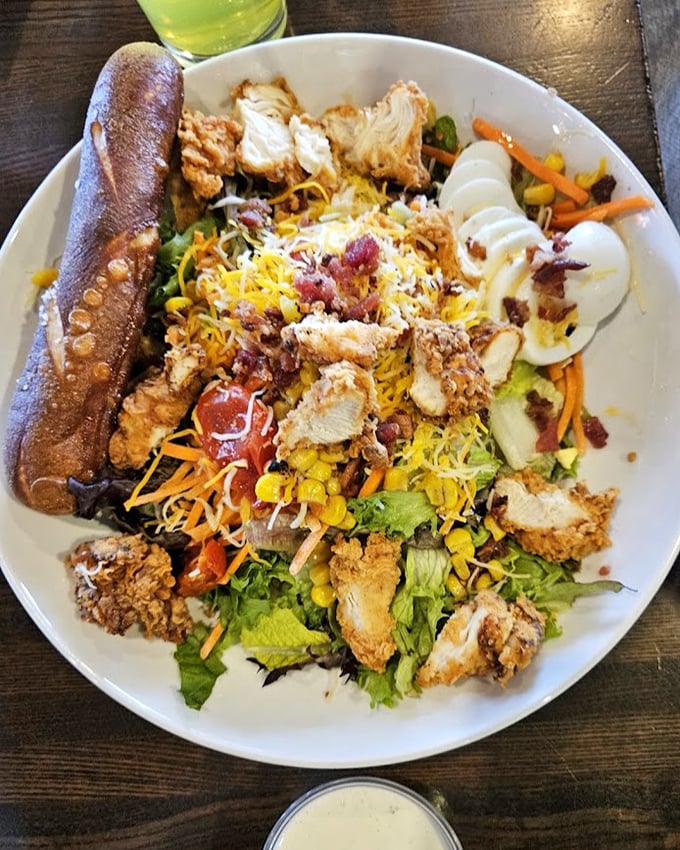 Not your average rabbit food—this chicken salad could convert the most dedicated carnivore. The breadstick stands guard like it knows how good everything else is.