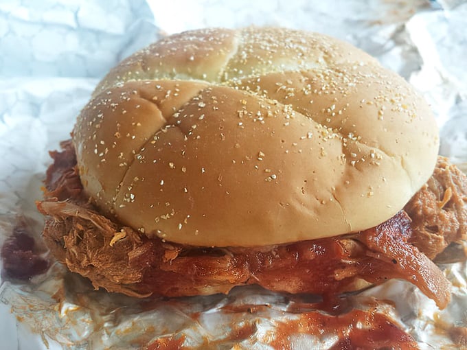 This pulled pork sandwich isn't just a meal, it's an engineering marvel—a perfect ratio of tender meat to soft bun that somehow defies the laws of sandwich physics.