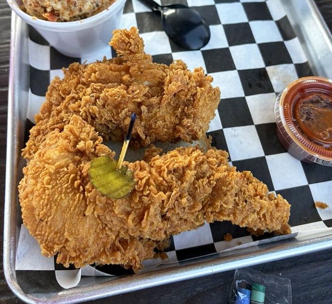 These aren't your average chicken tenders – they're armor-plated flavor missiles with a craggy exterior that shatters like delicious glass with each bite.