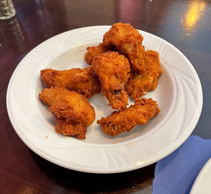 These golden-fried chicken wings aren't just appetizers—they're edible high-fives that crunch with each bite and make sharing optional.