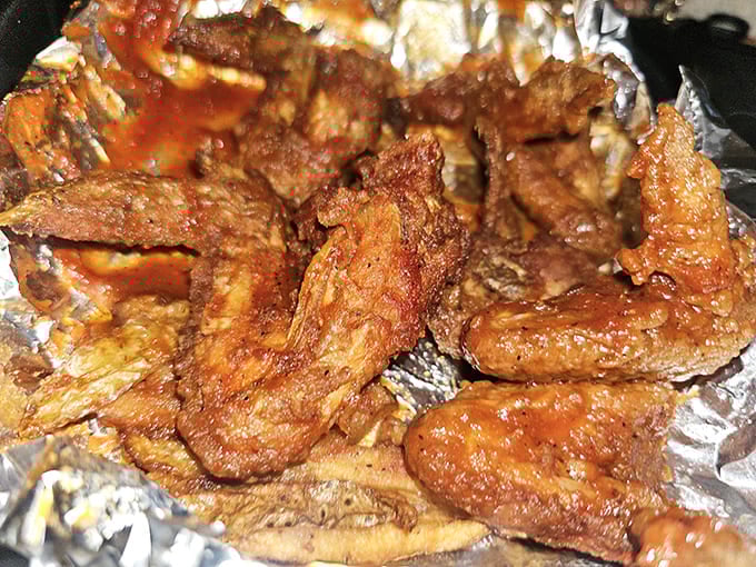These wings aren't just cooked; they're transformed into crispy, sauce-lacquered morsels that demand to be devoured immediately.