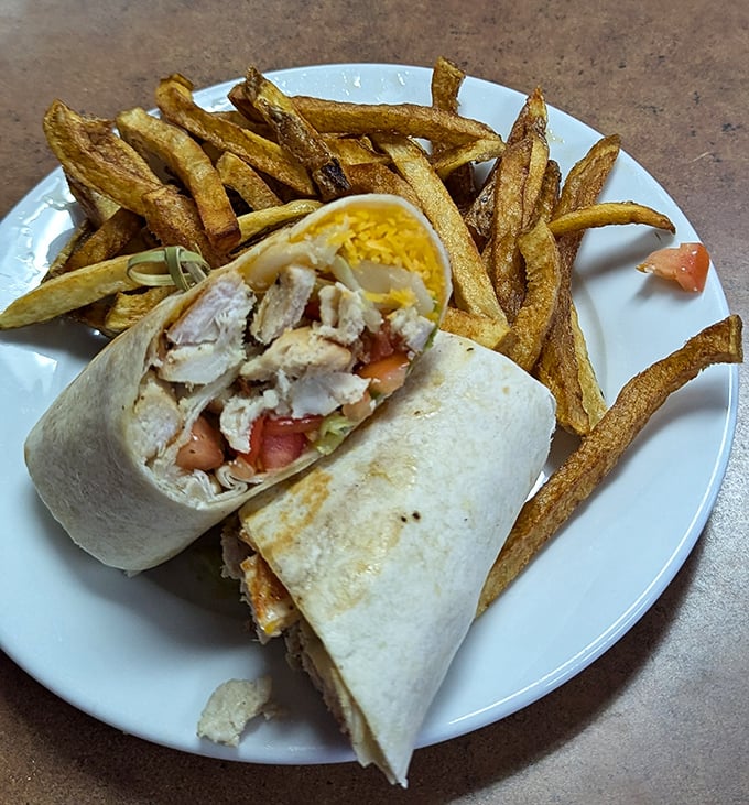 Wrapped perfection with a side of golden fries. This chicken wrap isn't just a meal—it's proof that simplicity done right is unbeatable.