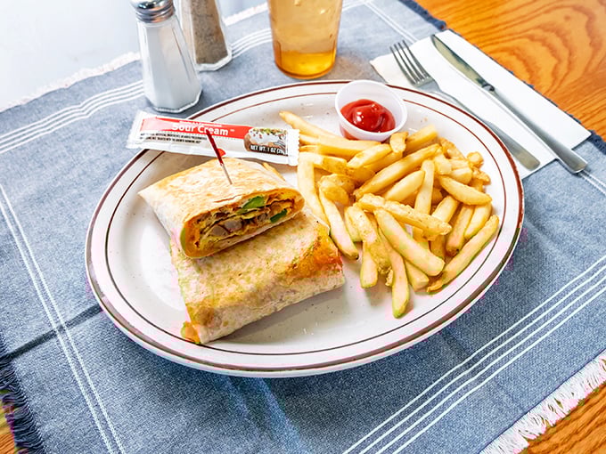 The breakfast wrap – where morning ingredients find their true calling wrapped in a warm tortilla, with fries standing by for moral support.