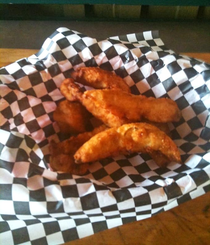 Golden-brown chicken tenders nestled in their checkered paper boat—simple pleasures that remind you why sometimes basic is beautiful.