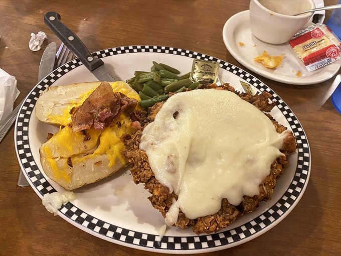 Chicken fried steak smothered in country gravy with cheesy potatoes on the side – cardiac concern has never looked so worth it.