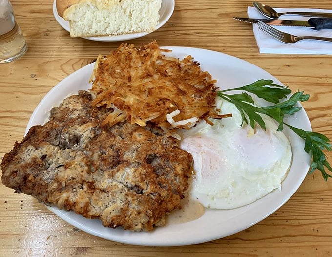 Chicken fried steak so perfectly golden it could win beauty contests, served alongside crispy hash browns.