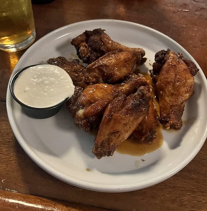 Wings so perfectly caramelized they make you wonder if they hired a chicken whisperer. That dipping sauce isn't optional – it's mandatory deliciousness.