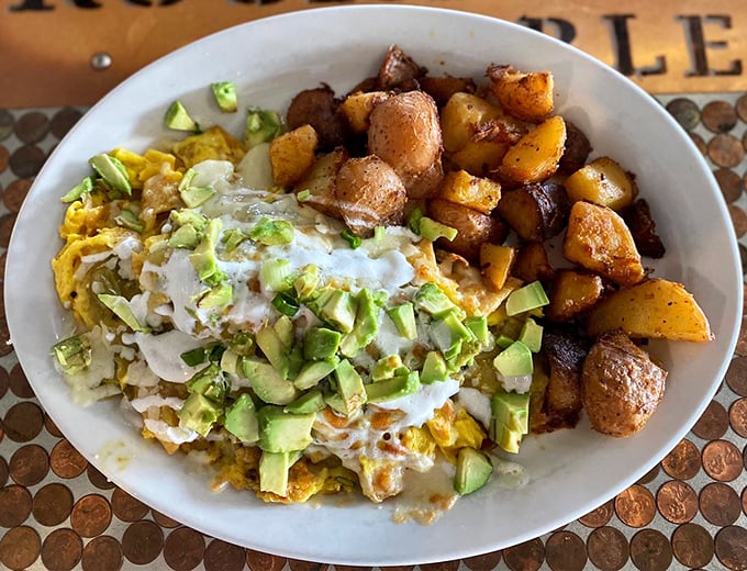 Chilaquiles that would make your abuela proud – crispy yet tender tortillas swimming in sauce, crowned with avocado and a drizzle of crema.