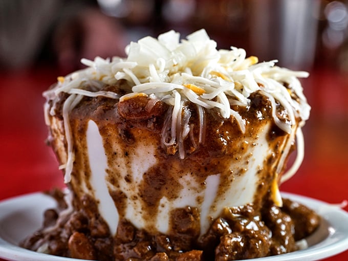 This mountain of chili atop a fluffy white throne isn't just a meal—it's a commitment to happiness that requires both napkins and possibly a nap afterward.