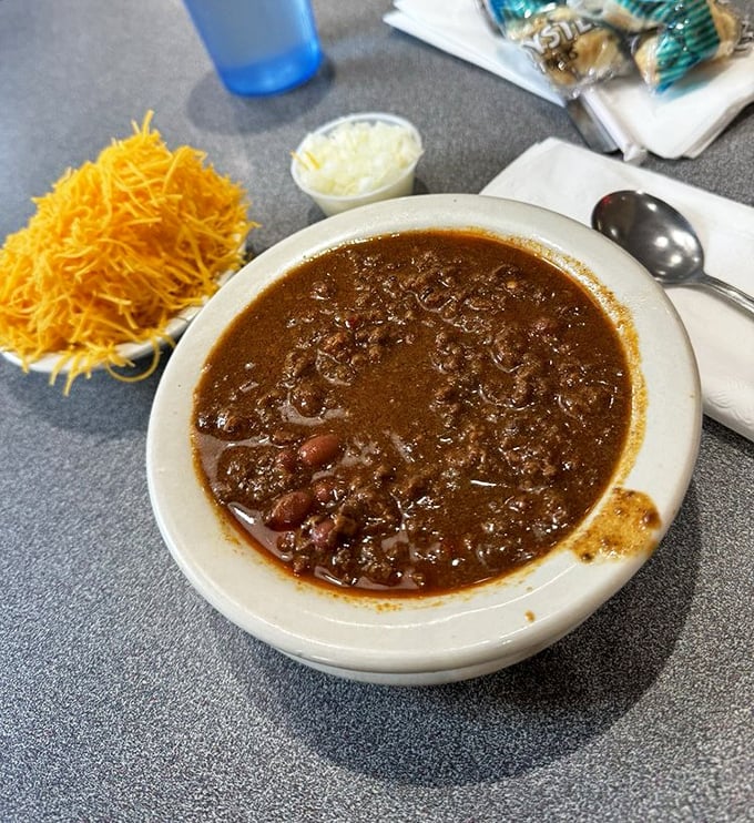 Cincinnati chili in its natural habitat—a savory, spiced meat sauce with hints of cinnamon and chocolate that defies traditional chili expectations.