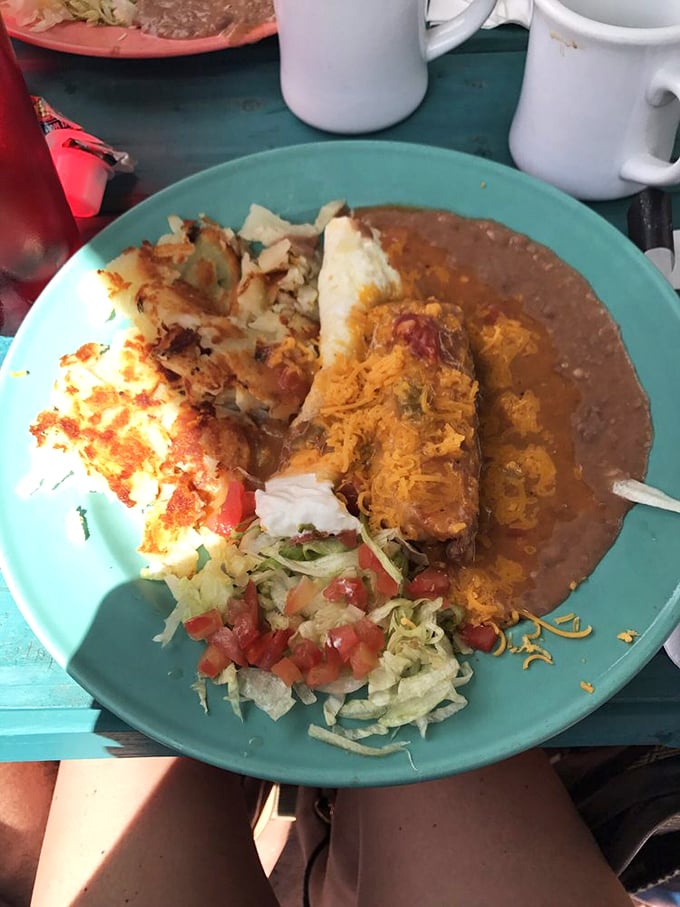 This isn't just a chili relleno—it's a masterclass in texture and flavor, nestled beside perfectly crisped potatoes and refried beans.