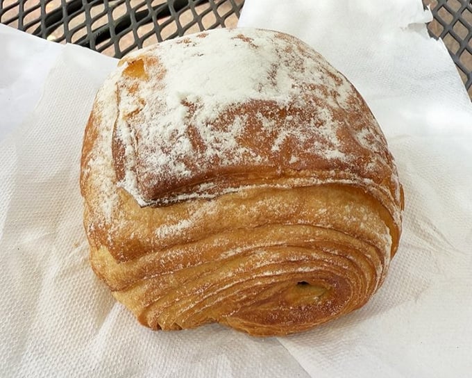 Layers upon buttery layers of pastry perfection. This powdered sugar-dusted croissant isn't just breakfast—it's a religious experience worth setting an alarm for.