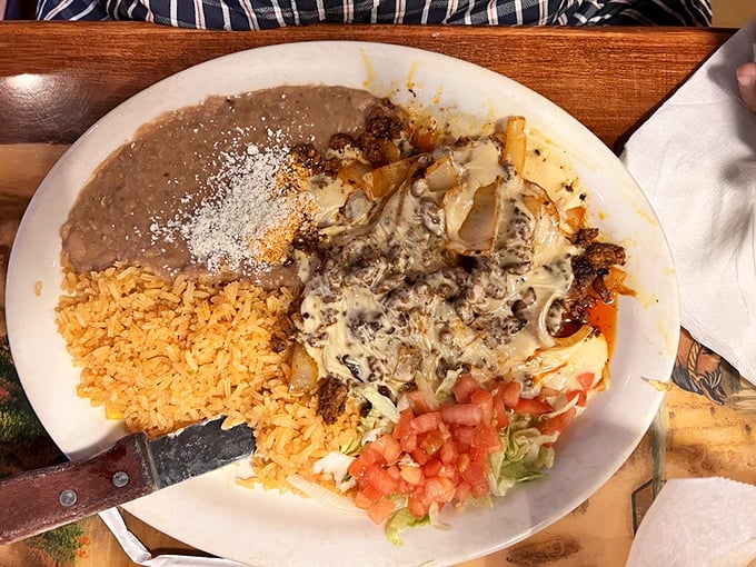 When cheese meets perfectly seasoned meat, magic happens. The rice and beans aren't sidekicks—they're essential supporting characters.