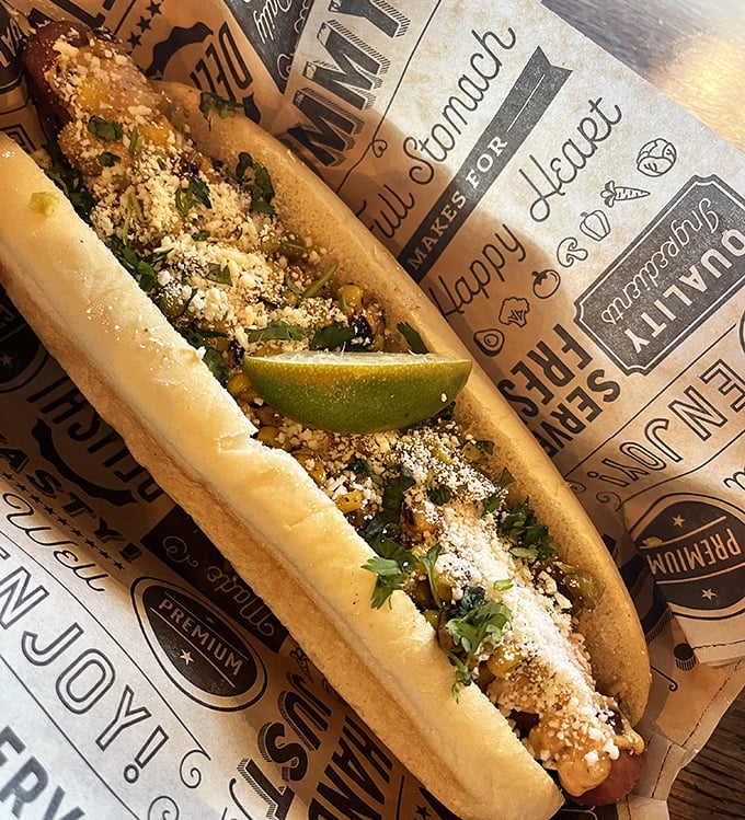 This isn't just a hot dog—it's a canvas of culinary creativity with cotija cheese and fresh lime. Street food elevated to an art form.