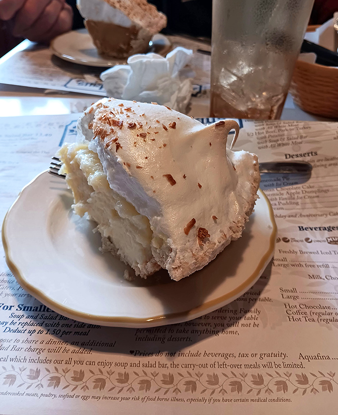 This coconut cream pie doesn't just have height—it has presence. The meringue stands taller than my retirement dreams.
