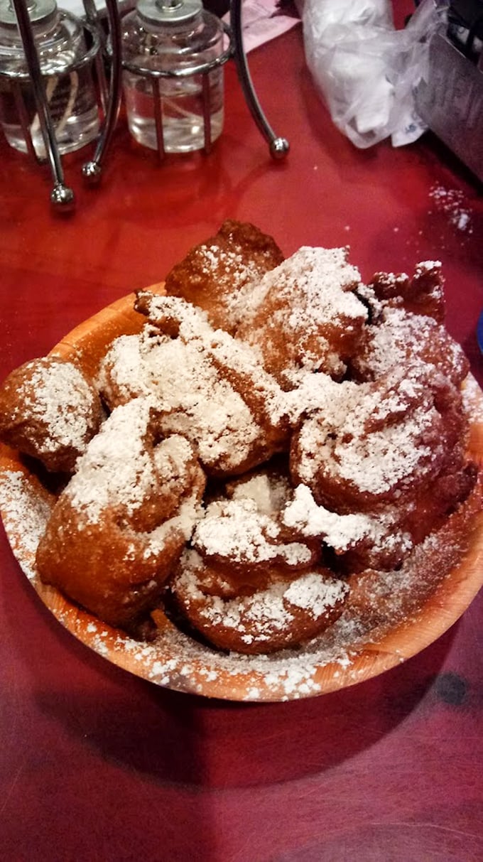 These powdered sugar-dusted corn fritters aren't just dessert—they're little clouds of happiness that make you wonder why vegetables ever bothered being healthy.
