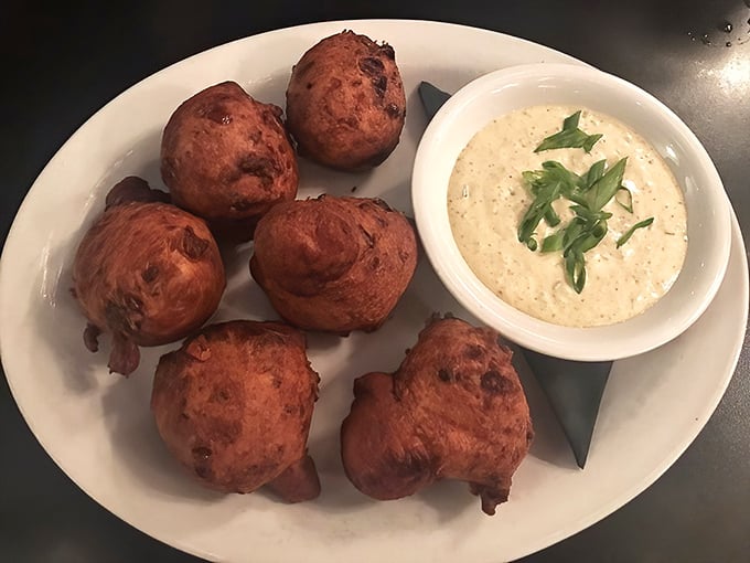 These aren't just any corn fritters—they're golden orbs of happiness served with a creamy dipping sauce that makes you question all other appetizers.