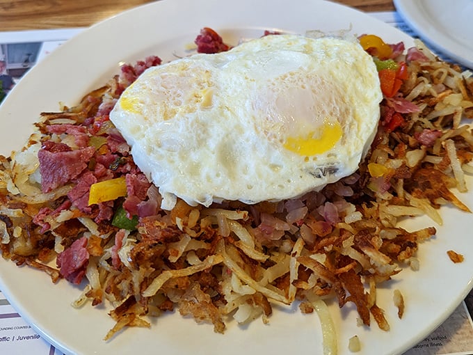 Corned beef hash crowned with a sunny-side-up egg – breakfast royalty that turns ordinary mornings into occasions worth getting out of bed for.