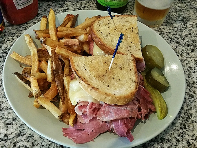 The Reuben sandwich here doesn't just have corned beef—it has a skyscraper of it. Those house-made pickles on the side? The perfect acidic counterpoint.