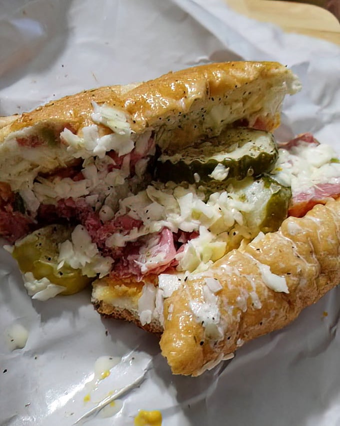 This sandwich cross-section reveals the beautiful stratification of flavors—like geological layers of deliciousness that took minutes, not millennia, to form.