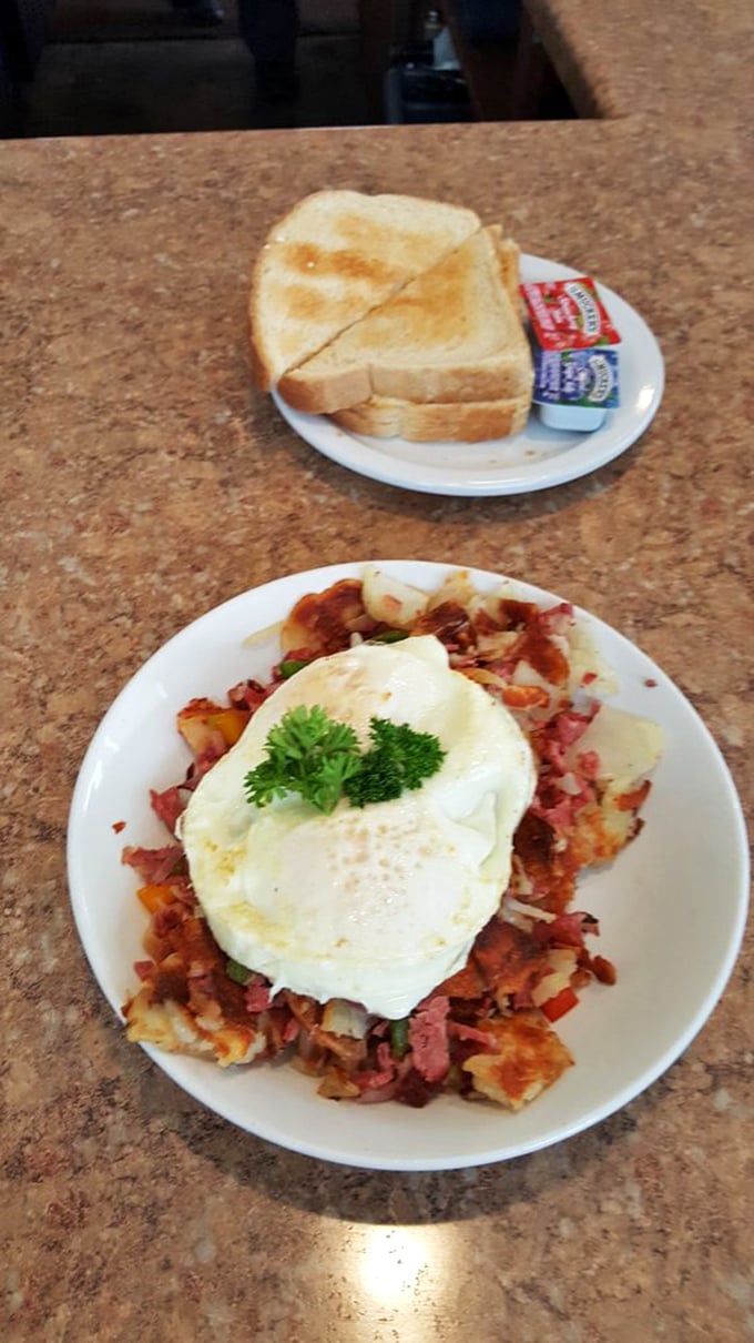 Corned beef hash topped with a perfectly fried egg – the breakfast equivalent of finding an extra $20 in your winter coat pocket.