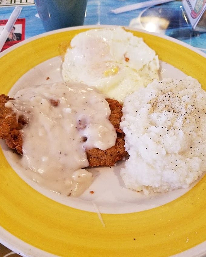 Country fried steak smothered in gravy that's thicker than the plot of a soap opera, with eggs and mashed potatoes standing by for support.