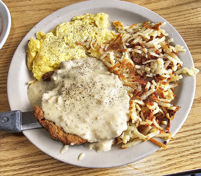 Country-fried steak smothered in gravy with hash browns crispy enough to make a potato proud – comfort food that hugs you from the inside. 