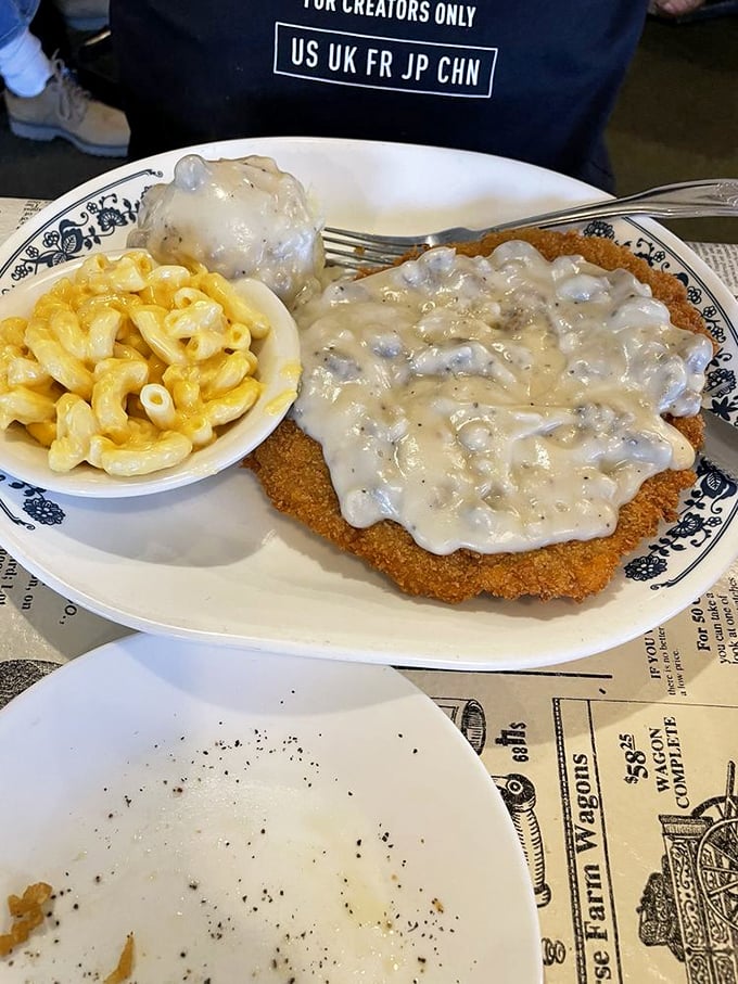 Country fried steak swimming in gravy like it's taking a victory lap around your childhood memories.