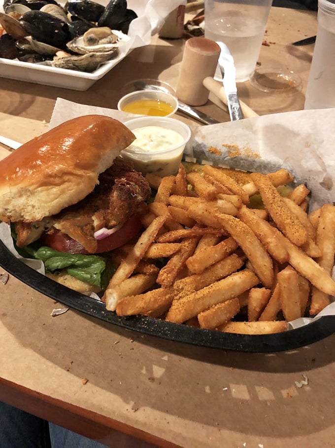 This isn't just a sandwich; it's Baltimore's soul between bread—a perfectly golden crab cake with minimal filler and maximum flavor.