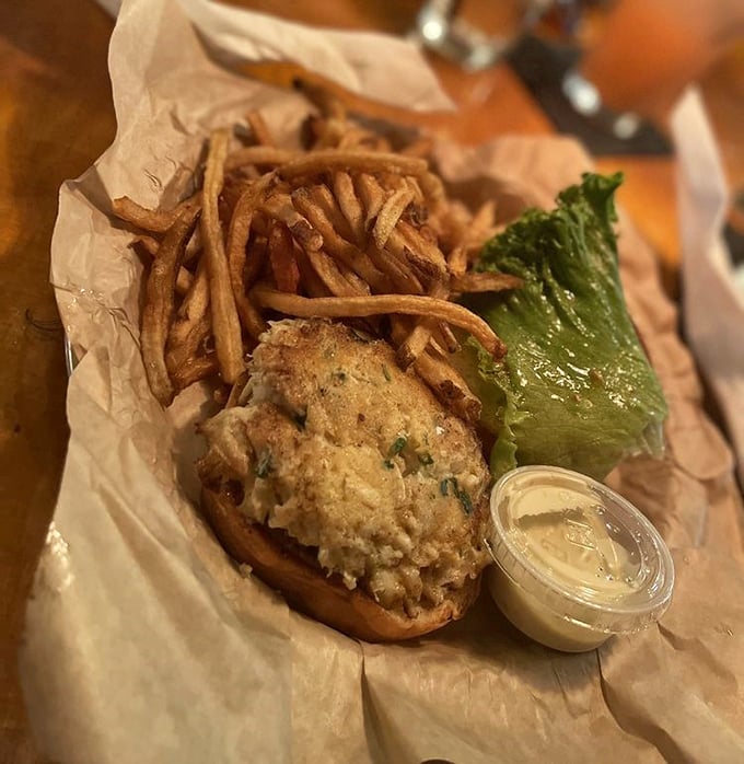 The crab cake sandwich—where Maryland tradition meets Norfolk hospitality. That golden-brown patty practically whispers "I'm mostly crab, not filler" with every bite.