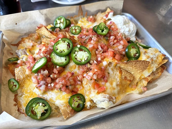 Nachos reimagined by Neptune himself—crispy chips buried under an avalanche of cheese, pico, and jalapeños that'll make you forget ordinary nachos exist.