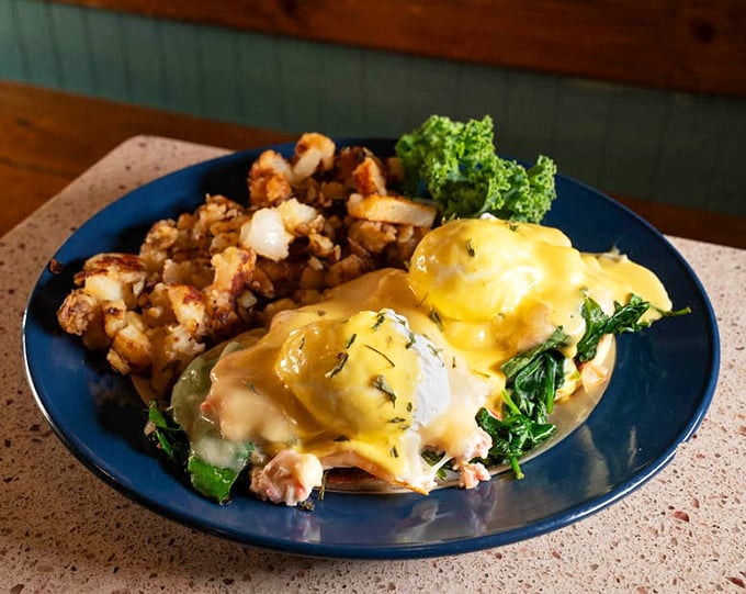 The Eggs Benedict's sophisticated coastal cousin—crab benedict with golden hollandaise cascading down like a sunrise over Tampa Bay.