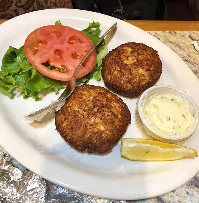 Golden-brown crab cakes that don't hide behind fillers – just pure crabby goodness with a side of "yes, this is why you came here."